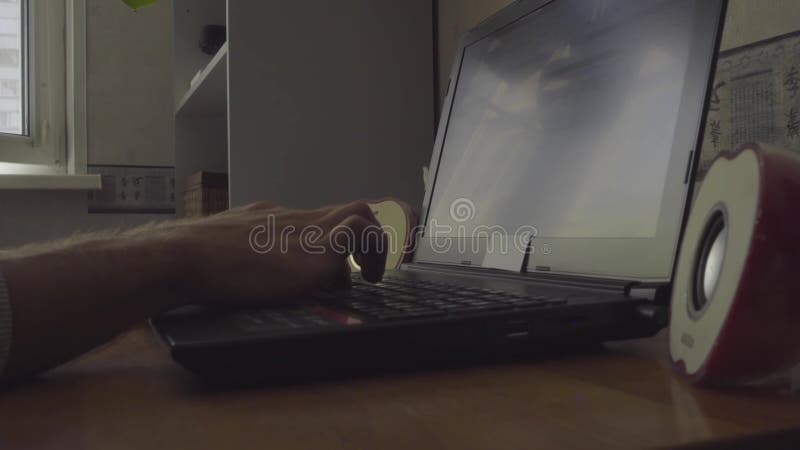 Cg. a Man Behind a Laptop with a Smartphone in His Hand Demonstrates ...