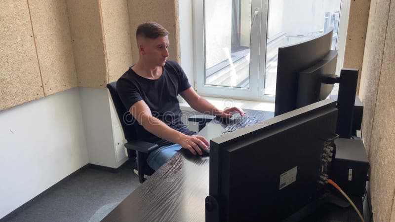 Man Works at a Computer Types Text on the Keyboard and Clicks the ...