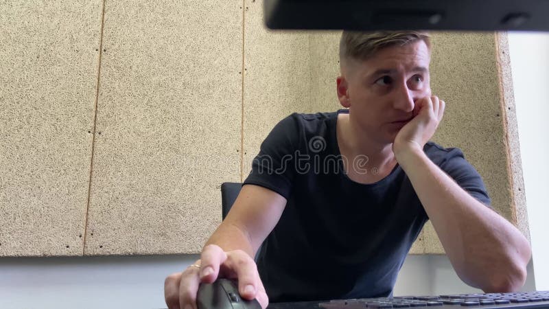 Man Works at a Computer Types Text on the Keyboard and Clicks the ...