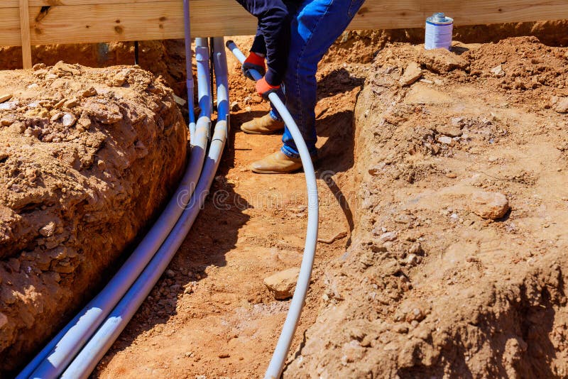 Focused Man Installing Conduit at Construction Site Outdoors Stock ...