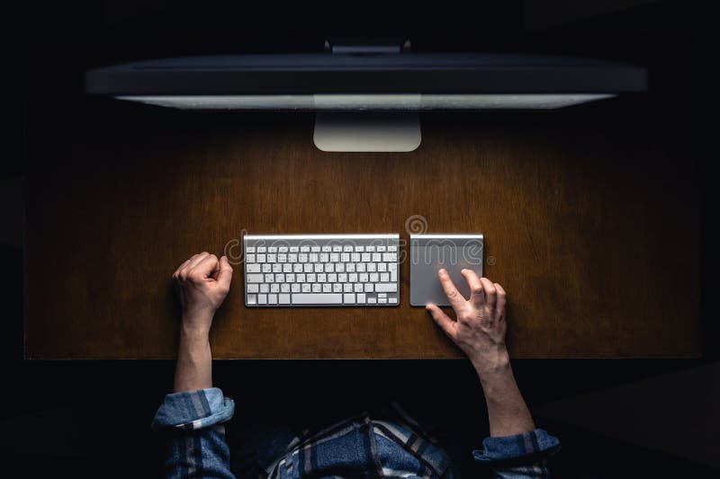 A Man Works in Front of a Computer at Night, Top View. Stock Photo ...
