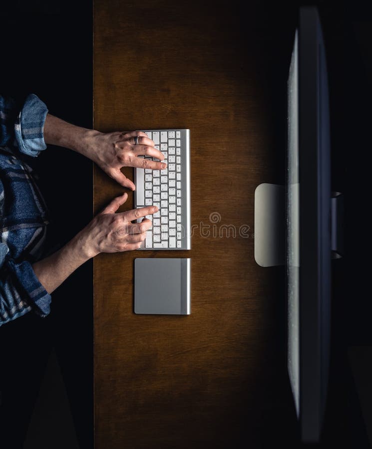 A Man Works in Front of a Computer at Night, Top View. Stock Image ...