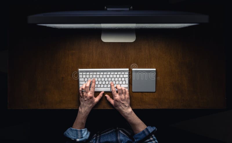 A Man Works in Front of a Computer at Night, Top View. Stock Photo ...