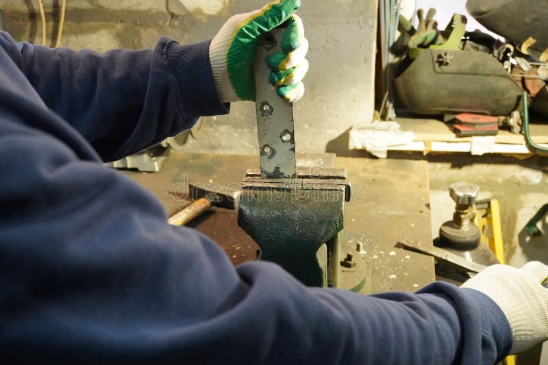 A Man Works in a Garage with Pieces of Iron Stock Photo - Image of ...