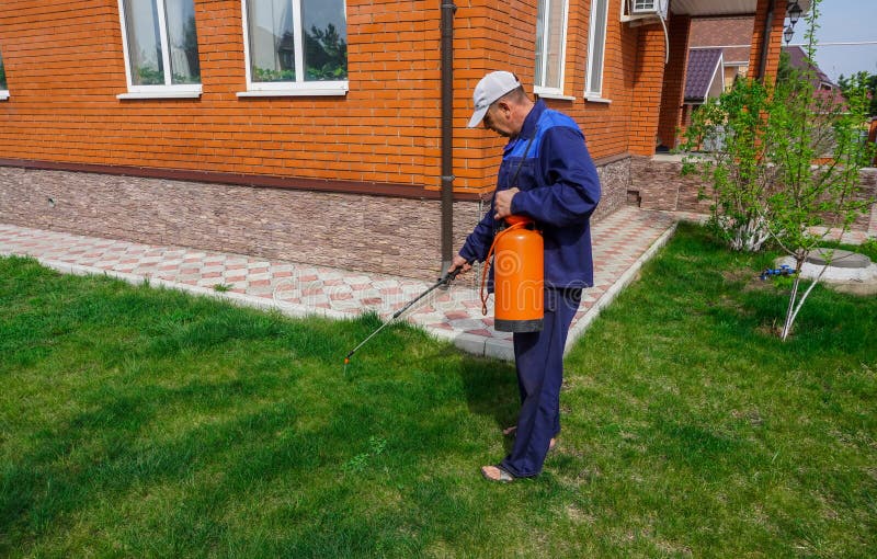 A Man Works in the Garden, Spraying Weeds from a Sprayer Stock Photo ...