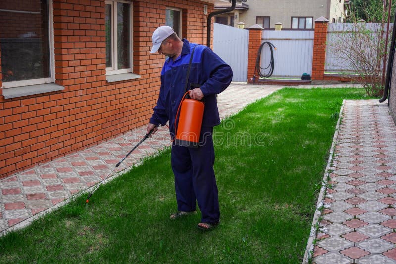 A Man Works in the Garden, Spraying Weeds from a Sprayer Stock Photo ...
