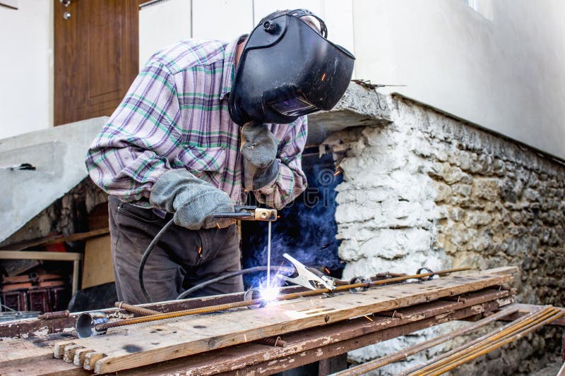 Work in the Industry. a Man Works with a Welding Machine Stock Photo ...