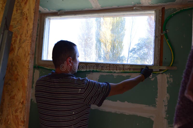 A Man Works in the Interior of the Repair and Construction Stock Image ...