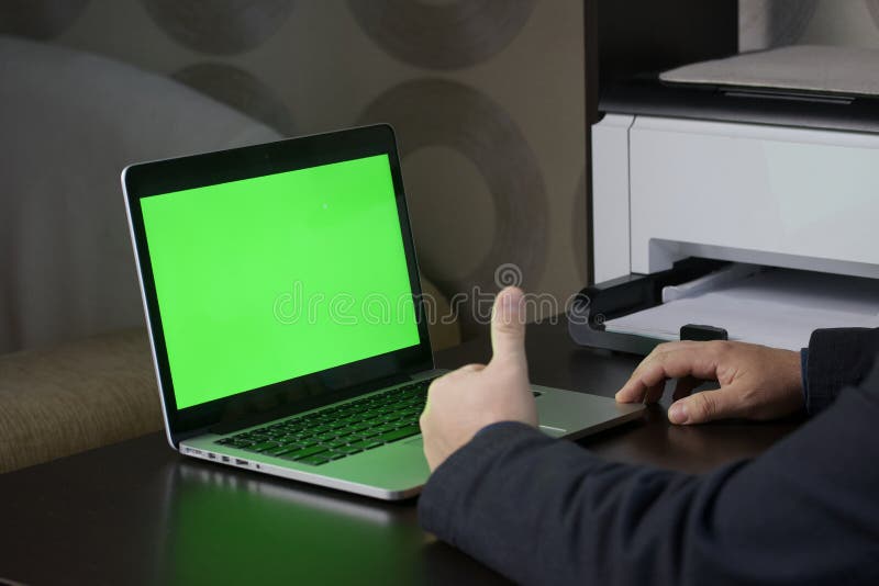 A Man Works at a Laptop with a Green Screen. Shows a Thumb Up Gesture ...