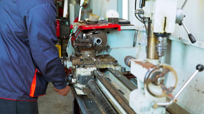 A man works on a lathe stock footage. Video of mechanical - 139622330
