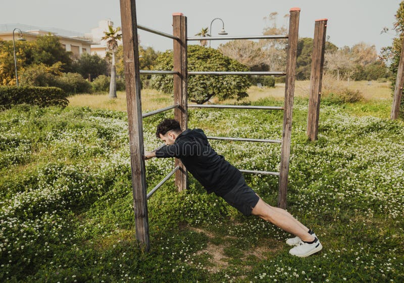 Man Works Out in Spring Outdoors Doing Push Ups Stock Photo - Image of ...
