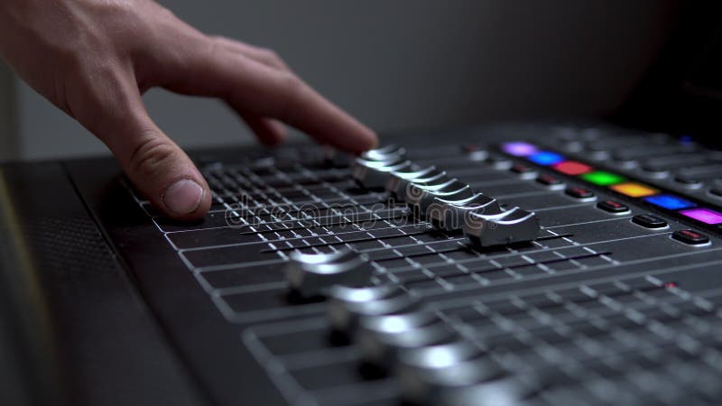Man Works on a Professional Electronic Audio Mixer. a Control Panel for ...