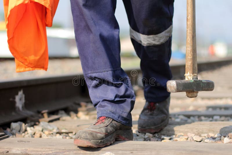 The Man Works at the Railroad. the Man with a Hammer Stock Photo ...