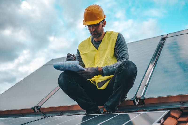 Man Works on Renewable Energy System with Solar Panel for Electricity ...