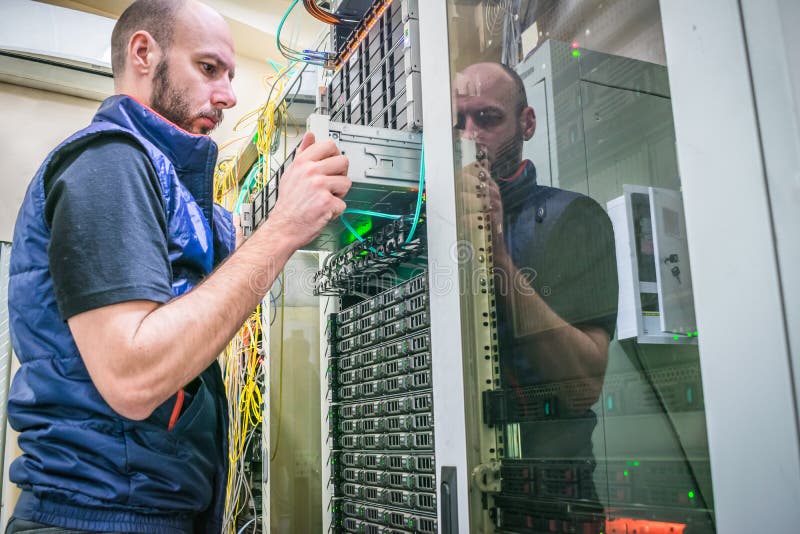 Technician Repairs the Central Router in the Datacenter Server Room ...