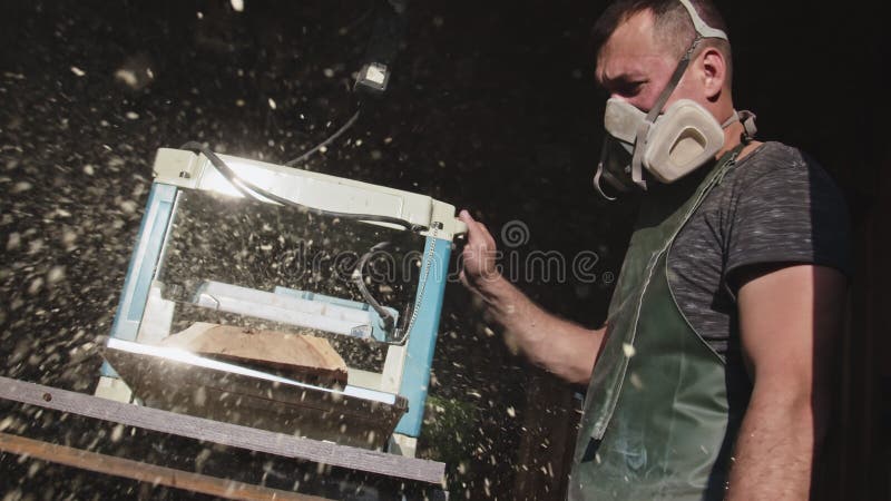 Closeup of a Man Carpenter Working with a Thickness Planer. Dust Flying ...