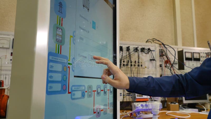 Man Works on a Touch Screen. Young Scientist Uses a Large Touch Screen ...