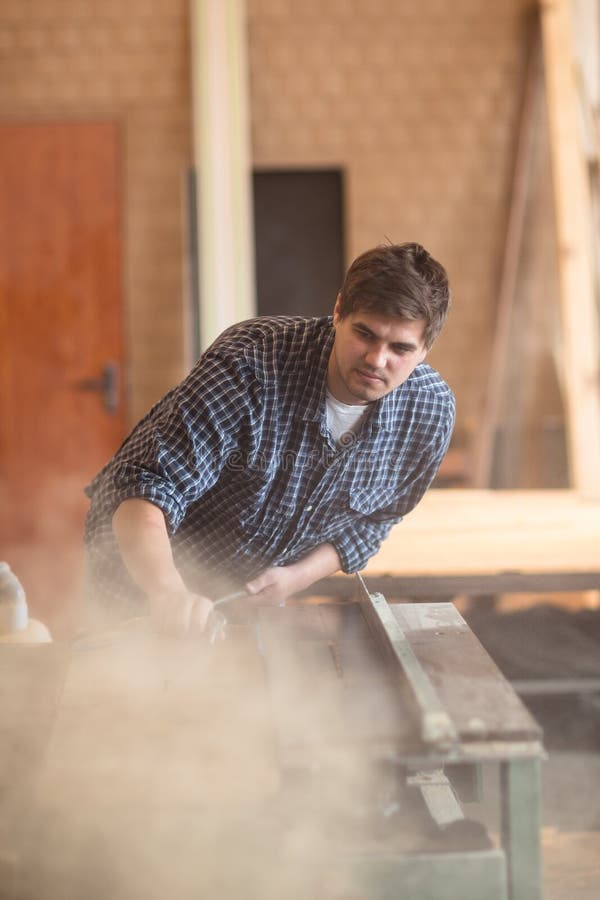 Man in Workshop, Carpentry Workshop Tidying, Dusting Pneumatic Stock ...