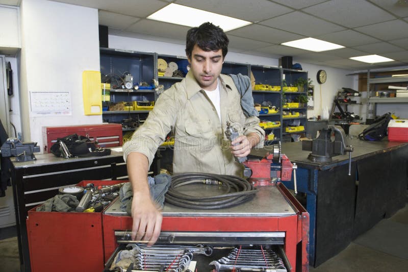 Man in Workshop with Tools stock photo. Image of person - 33907236