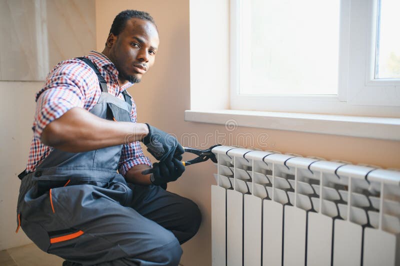 Man in Workwear Overalls Using Tools while Installing or Repairing ...