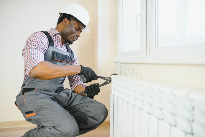 Man in Workwear Overalls Using Tools while Installing or Repairing ...