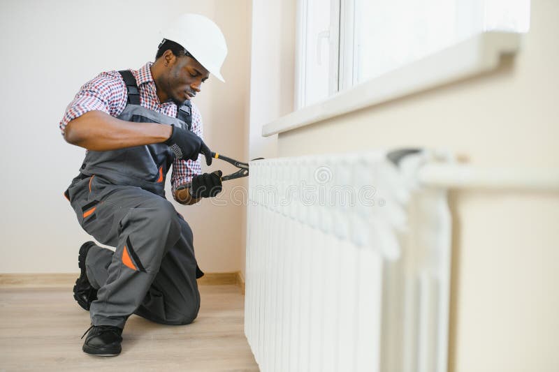 Man in Workwear Overalls Using Tools while Installing or Repairing ...