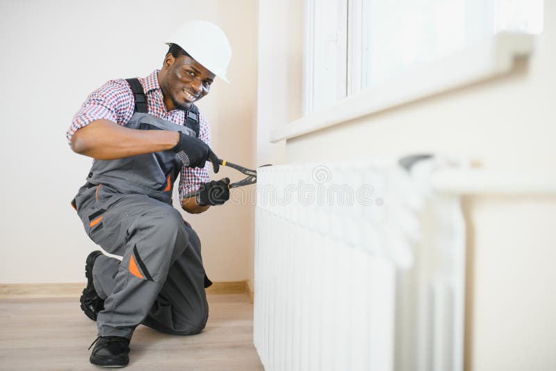 Man in Workwear Overalls Using Tools while Installing or Repairing ...