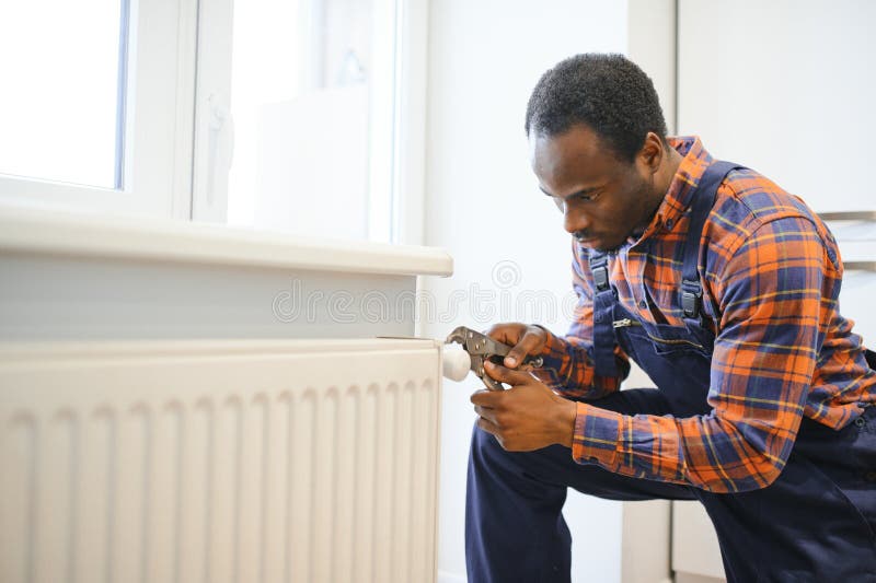 Man in Workwear Overalls Using Tools while Installing or Repairing ...