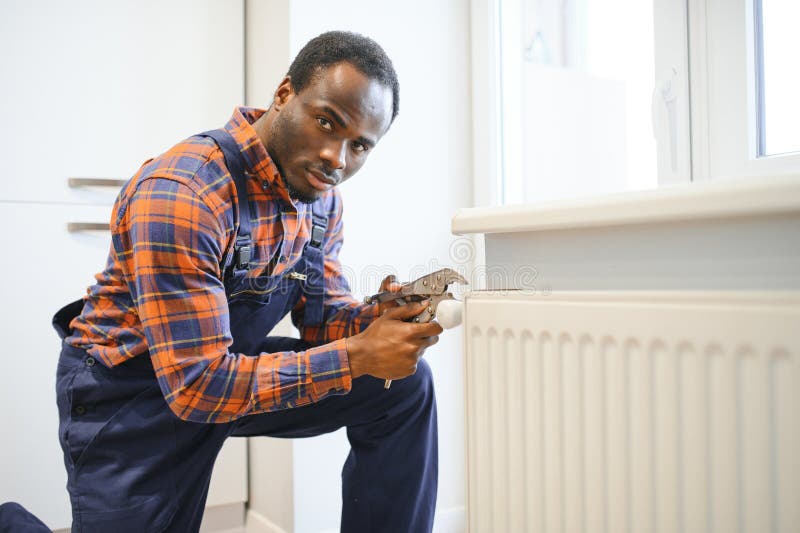 Man in Workwear Overalls Using Tools while Installing or Repairing ...