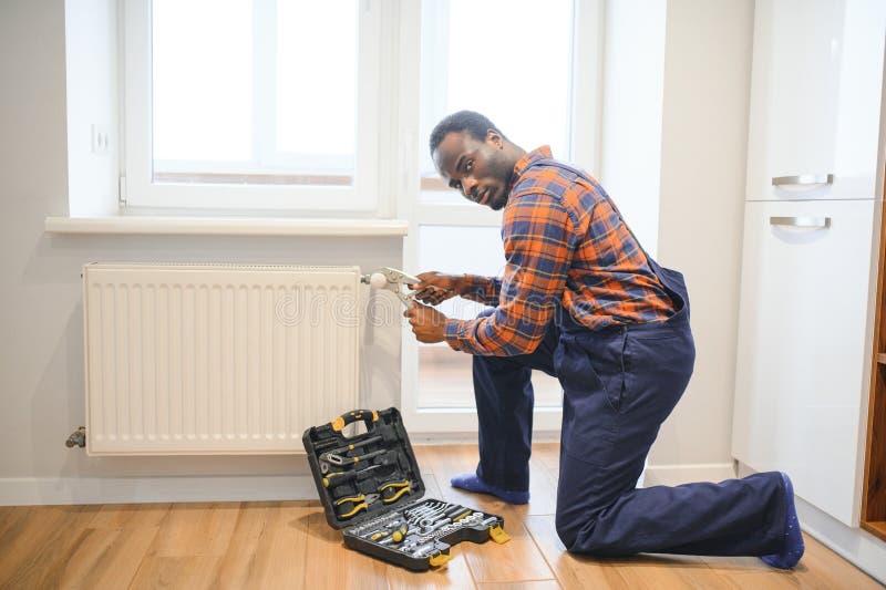 Man in Workwear Overalls Using Tools while Installing or Repairing ...