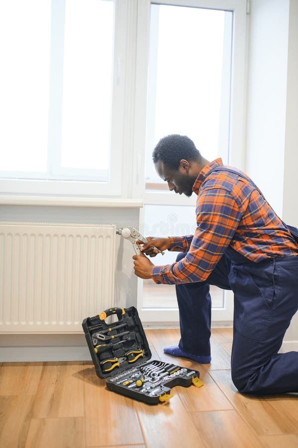 Man in Workwear Overalls Using Tools while Installing or Repairing ...