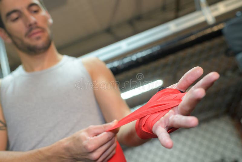 A Man Wrapping His Hand With A Bandage Stock Photo - Image of injured ...