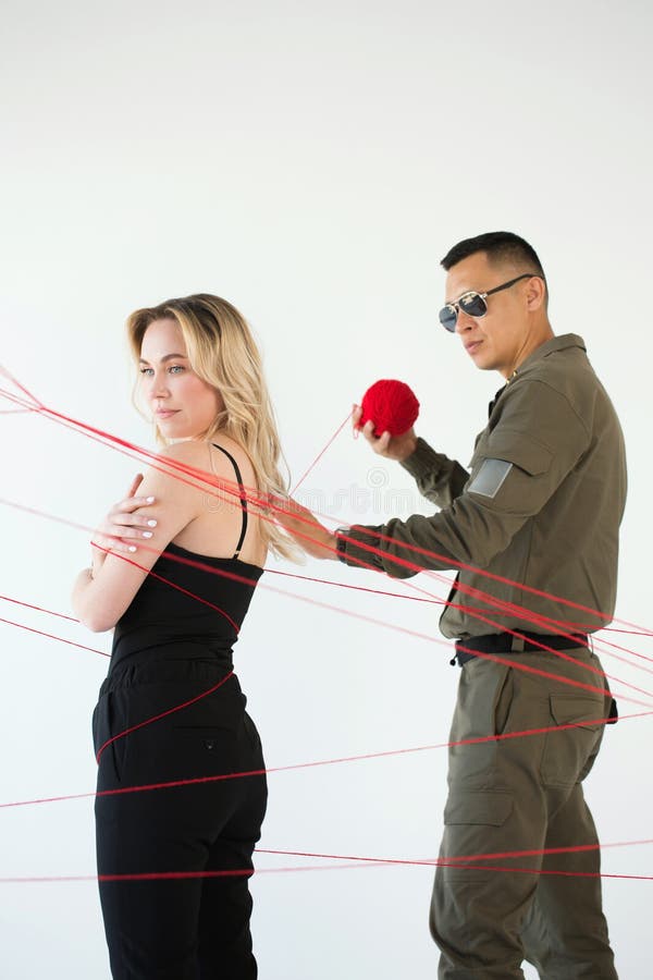 A Man Wraps Red Threads Around a Woman Stock Image - Image of ...
