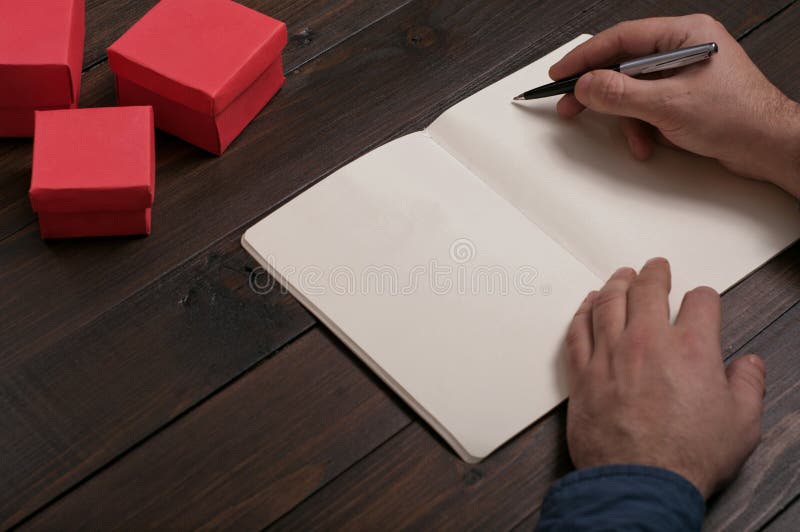 Man Writes a Message in a Notebook Stock Photo - Image of notepad ...