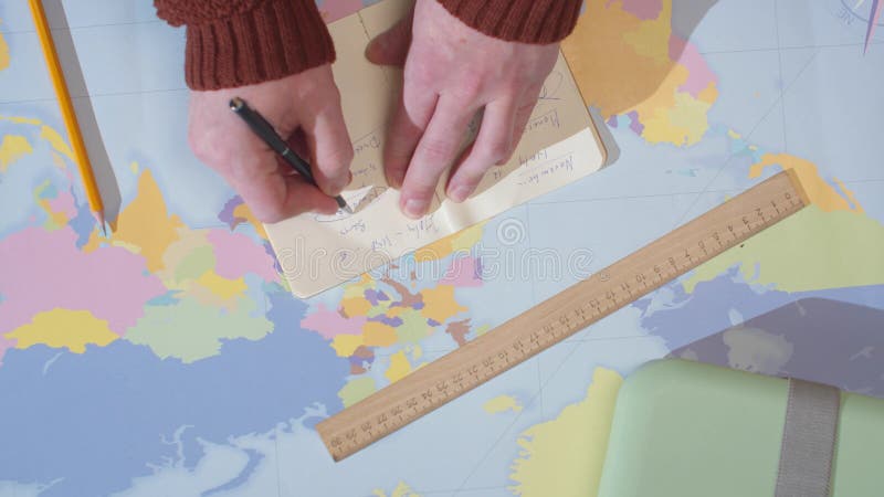 Adventurer Writes in a Notebook on a Table with a Map Stock Photo ...