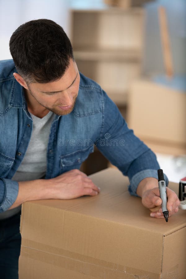 Man writing address on box stock image. Image of adult - 218901273