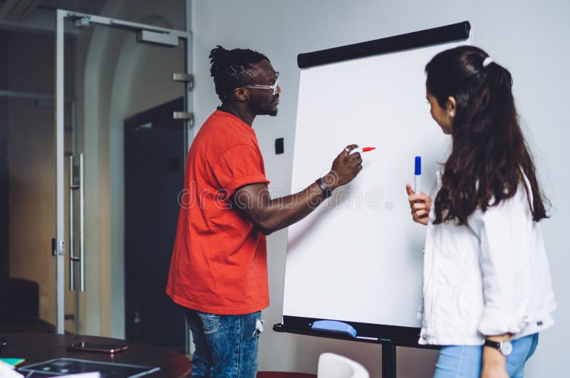 Man Writing on Board for Group Mates Stock Photo - Image of class ...
