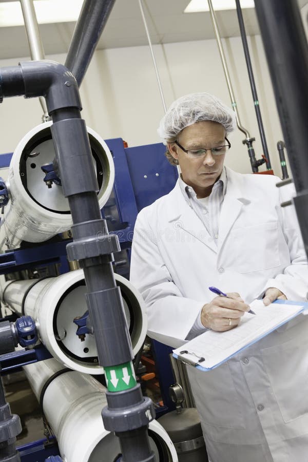 Man Writing in Clipboard while Standing in Bottling Factory Stock Image ...
