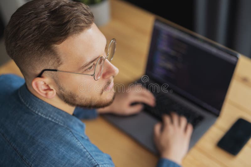 Man writing code on laptop stock photo. Image of meeting - 256316766