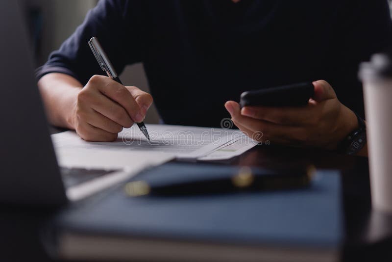 Man Writing Content or a Script on a Notepad with a Pen while Holding a ...