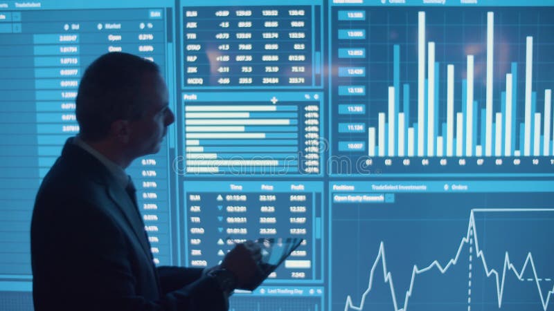 Man Writing Data on Tablet from Big Digital Screen Stock Footage ...