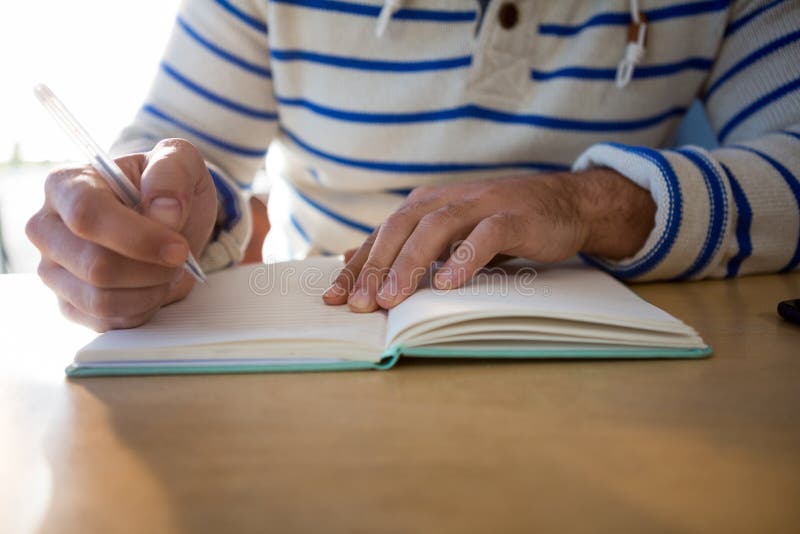 Man writing in a diary stock photo. Image of hospitality - 78683186