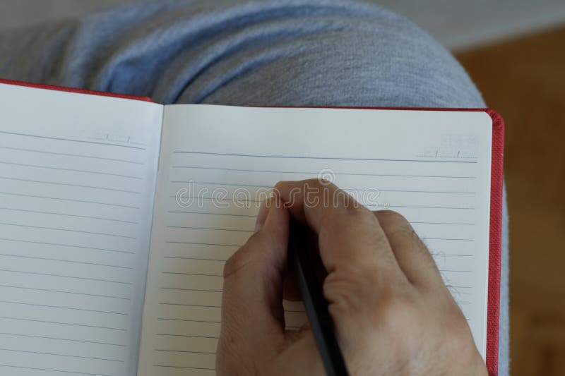 Man Writing or Drawing with Black Pen in a Notebook, Diary or Calendar ...