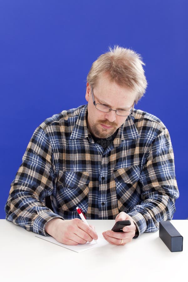 Man writing at his desk stock image. Image of serious - 13975313