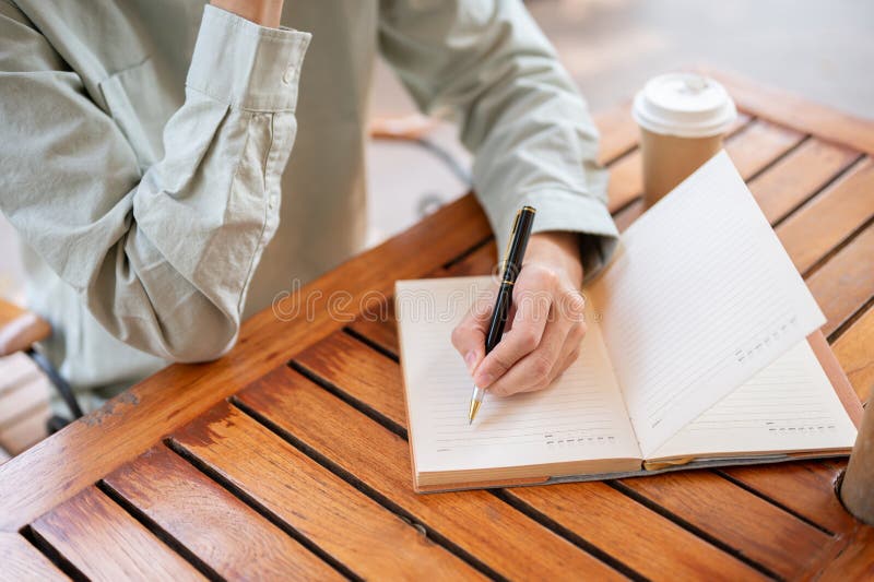 A Man Writing in His Notebook, Jotting Down Ideas, or Keeping a Diary ...