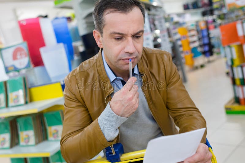 Man Writing in Notepad in Aisle at Supermarket Stock Image - Image of ...