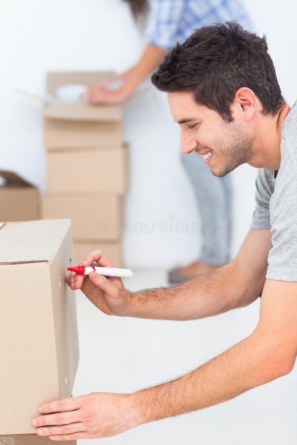 Man Writing with a Marker on a Moving Box Stock Photo - Image of house ...