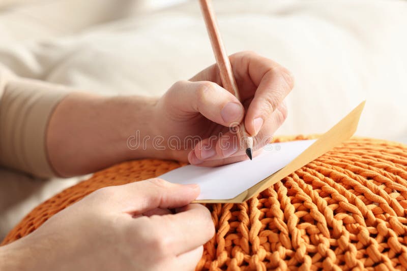 Man Writing Message in Greeting Card on Orange Stock Image - Image of ...