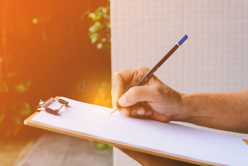Man Writing a Message on it Paper on Clipboard Stock Photo - Image of ...