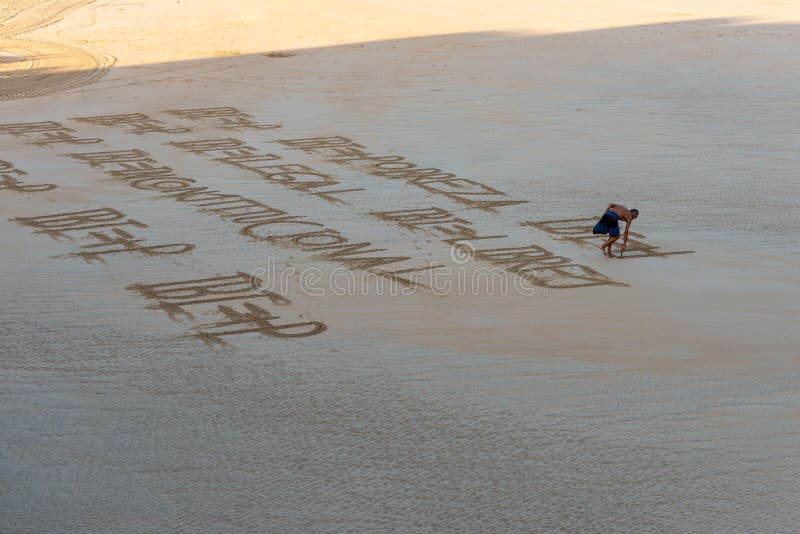 Man Writing a Message in the Sand Editorial Photography - Image of ...